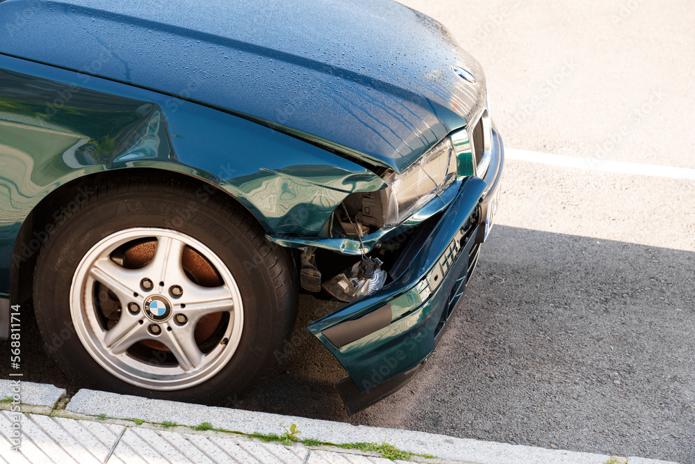 Damaged crashed BMW car with broken headlight and and bumper after ...