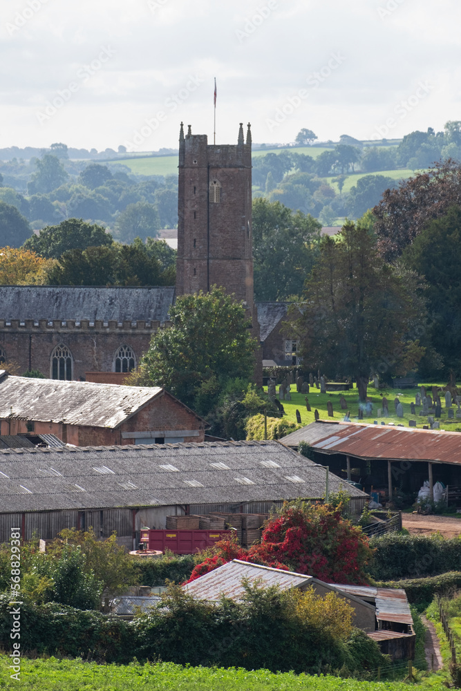 The parish church at Halberton in mid Devon UK. The red stone church ...