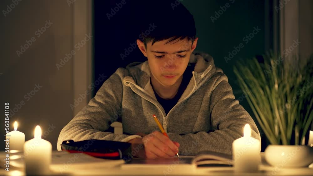 Schoolgirl distance learning at home without light by candlelight in ...