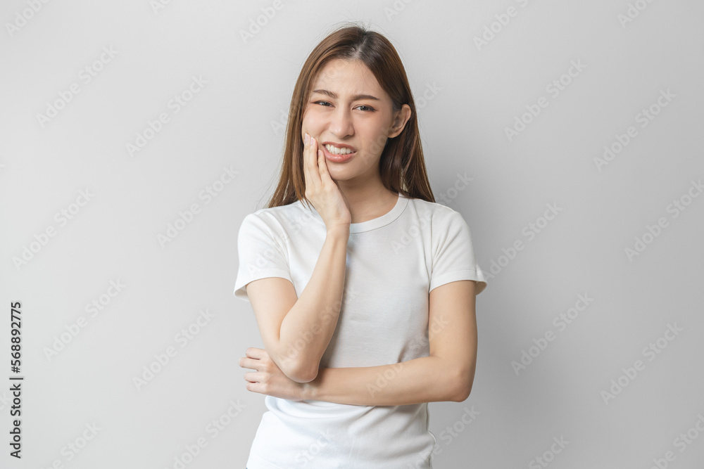 Foto de Face expression suffering from sensitive teeth and cold, asian ...