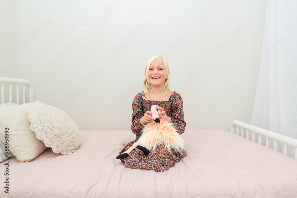Happy girl holding stuffed animal Stock Photo | Adobe Stock