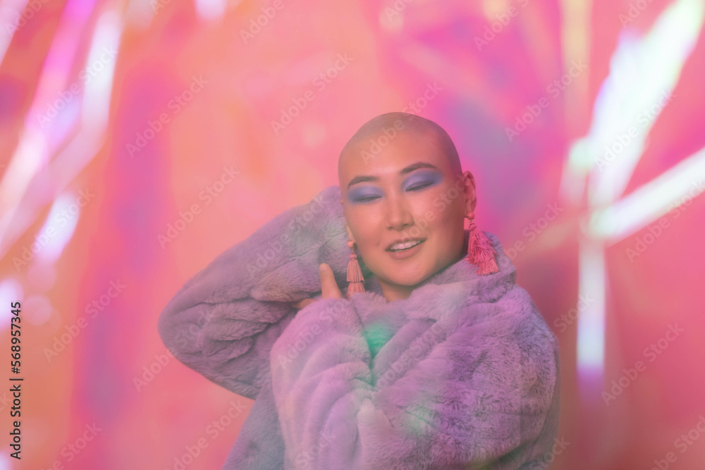 Stylish bald Gen Z woman dancing with iridescent effect in camera Stock ...