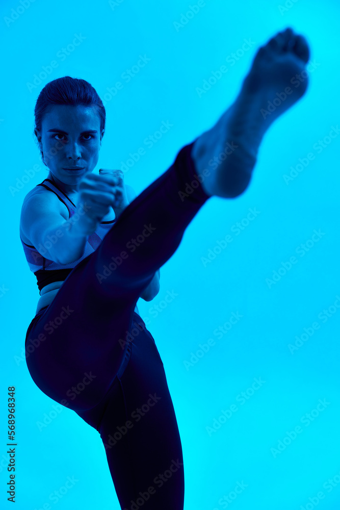 Strong female fighter kicking air Stock Photo | Adobe Stock