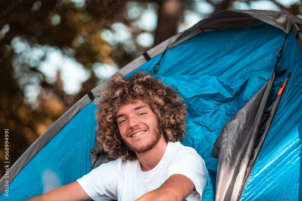 Foto de A man camping with a tent. He is surrounded by a beautiful ...