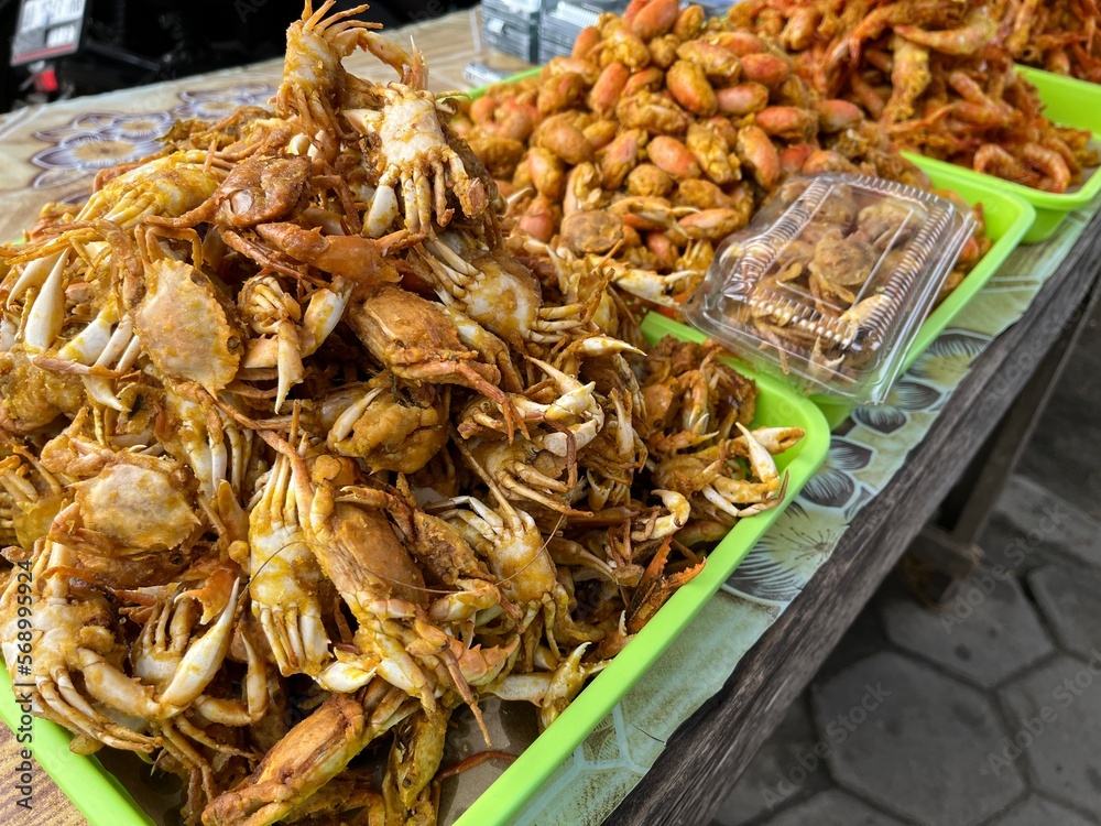 Local street food vendor selling deep fried crispy baby crab and sand ...