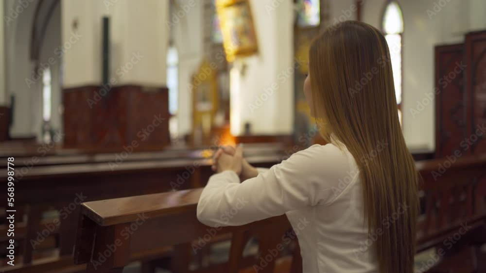Asian Vietnamese woman praying in empty christian church with cross ...