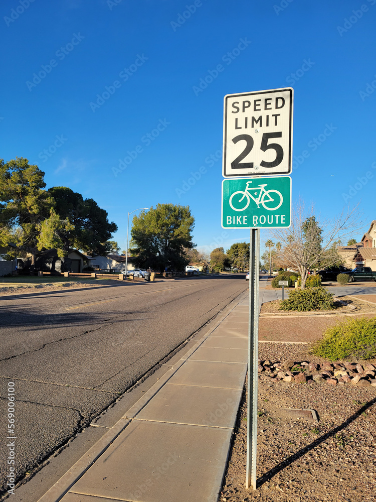 Brightly lit by early morning sun road signs for bicyclists and ...