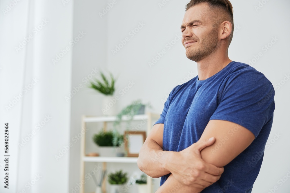 A man has pain in his arm, sprain of muscles and ligaments during ...