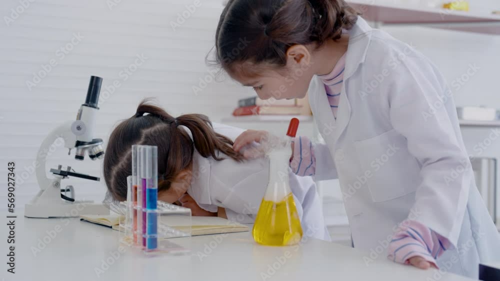 4K, Two schoolgirls, wearing glued shirts, classroom, doing chemistry ...