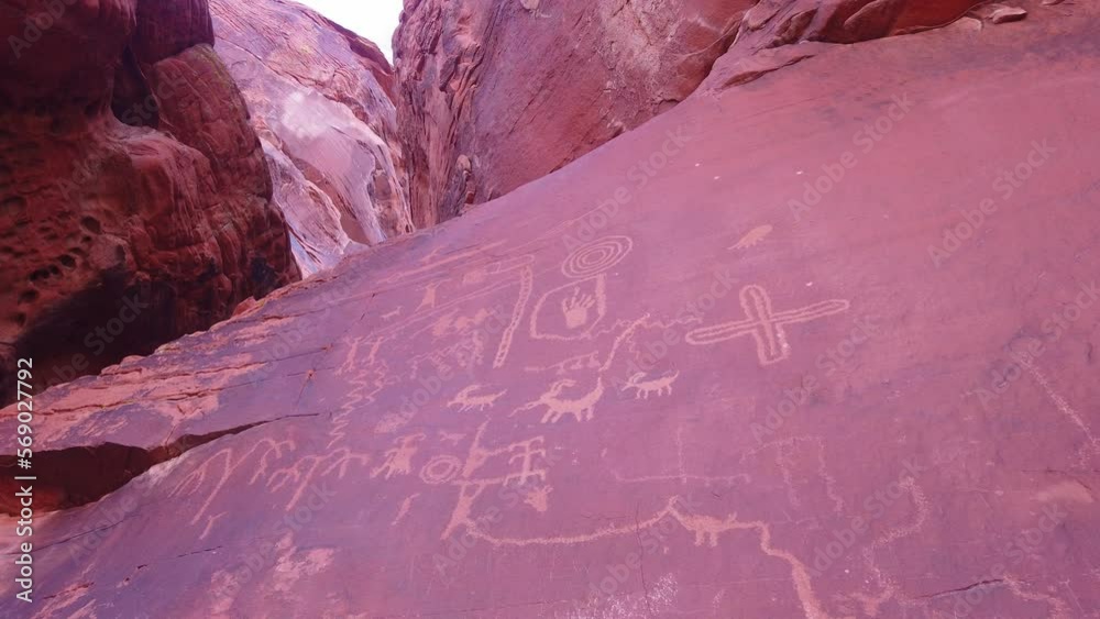 Gimbal close-up panning shot o ancient petroglyphs carved into the ...