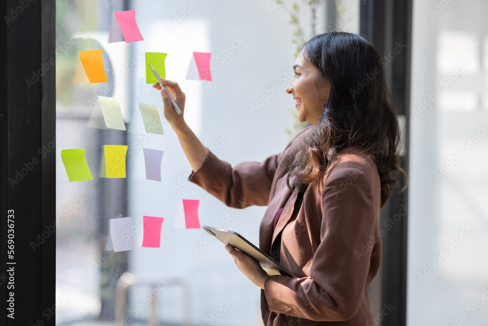 Young Indian Girl Asian Woman Entrepreneur Of Small Company Putting A Adhesive Sticky Notes In