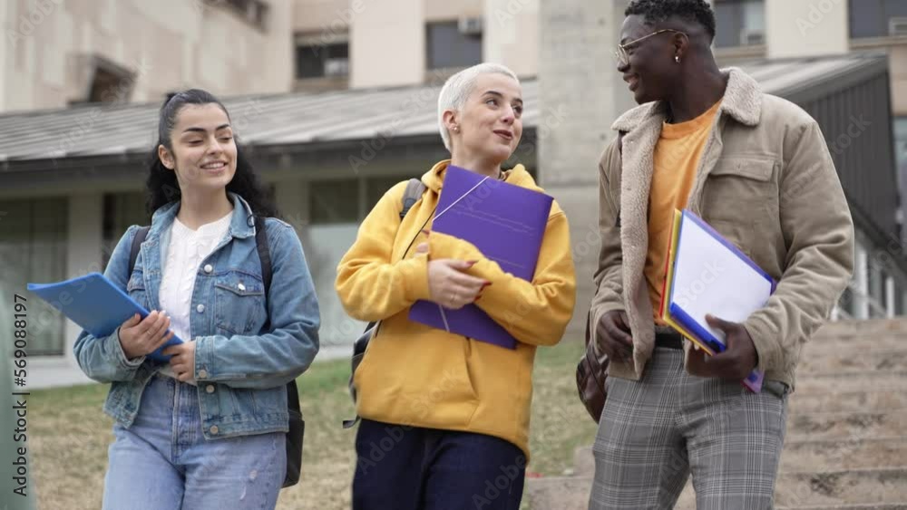 University students wearing casual clothes carrying backpacks and ...
