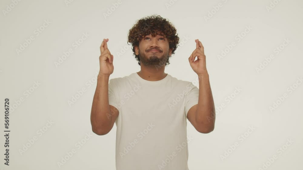 Excited young man showing hope gesture. Indoor footage of handsome guy ...
