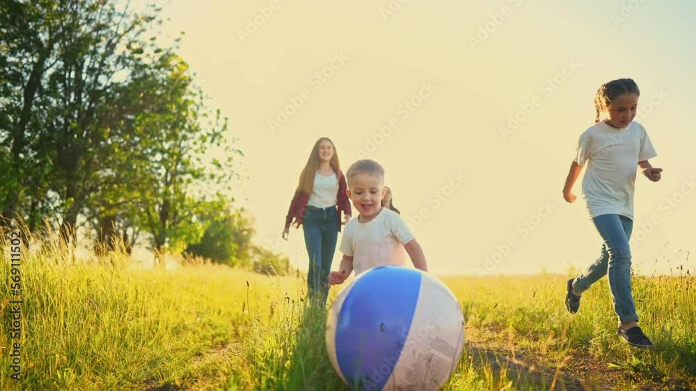 children playing ball in the park. happy family a kid dream concept. a ...