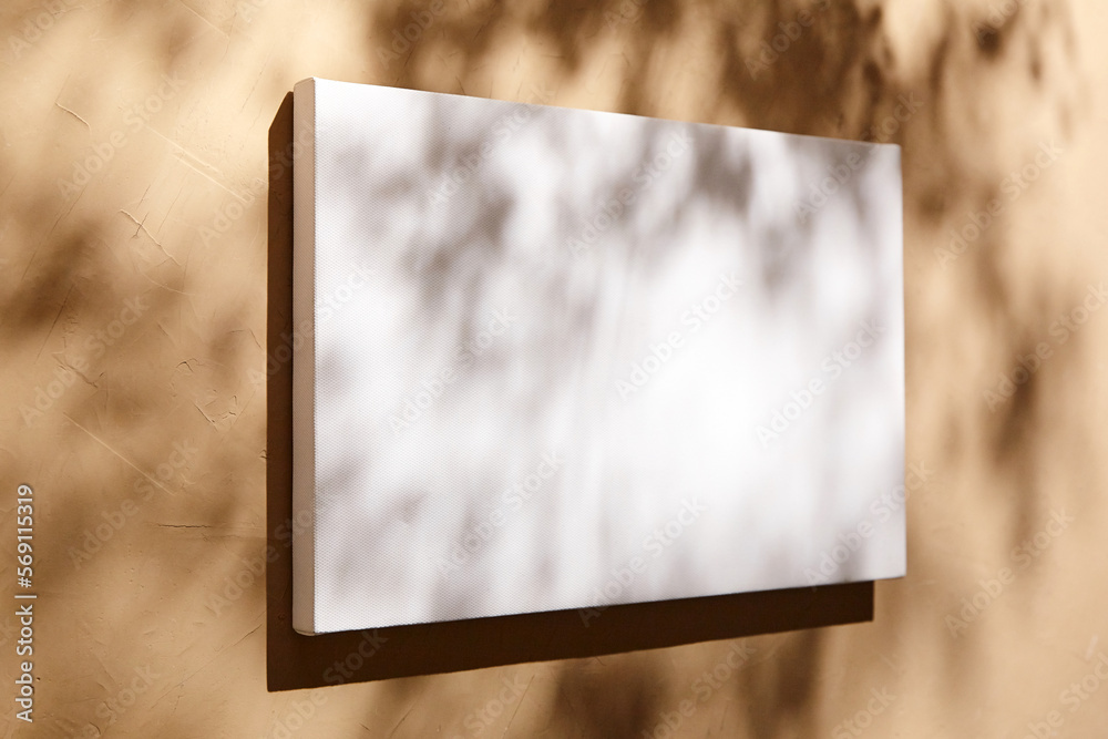 White canvas, blank picture mockup hanging on beige wall with dark ...
