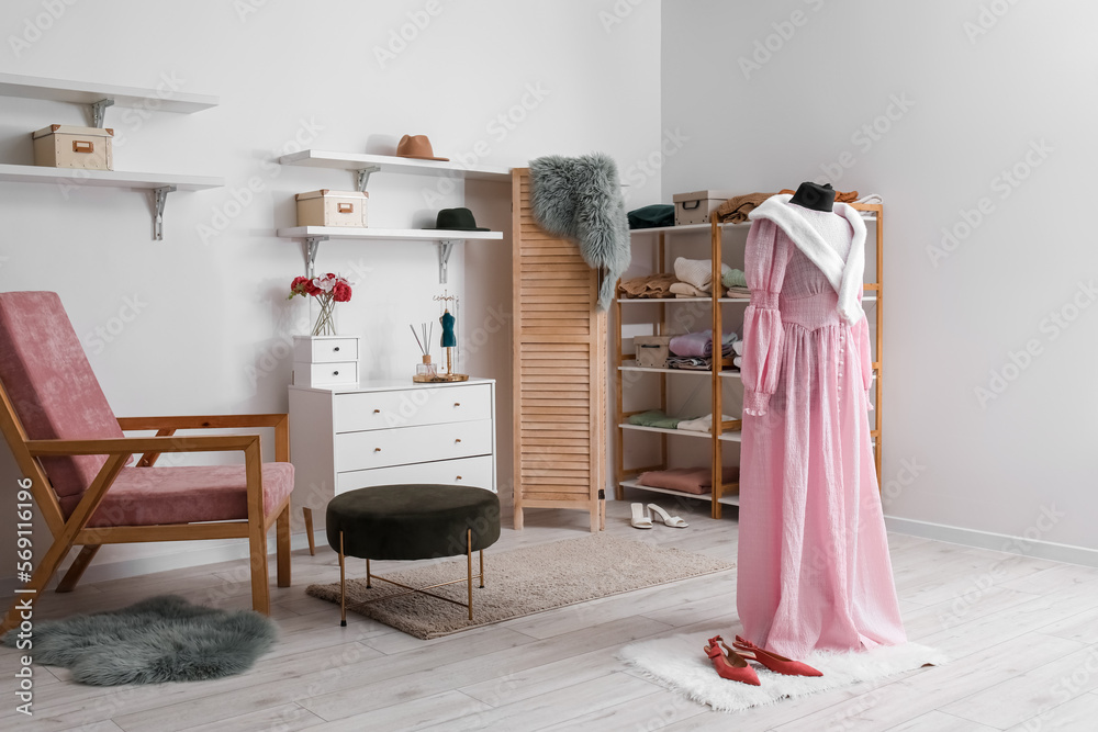Interior of fashion designer's studio with mannequin, clothes and ...