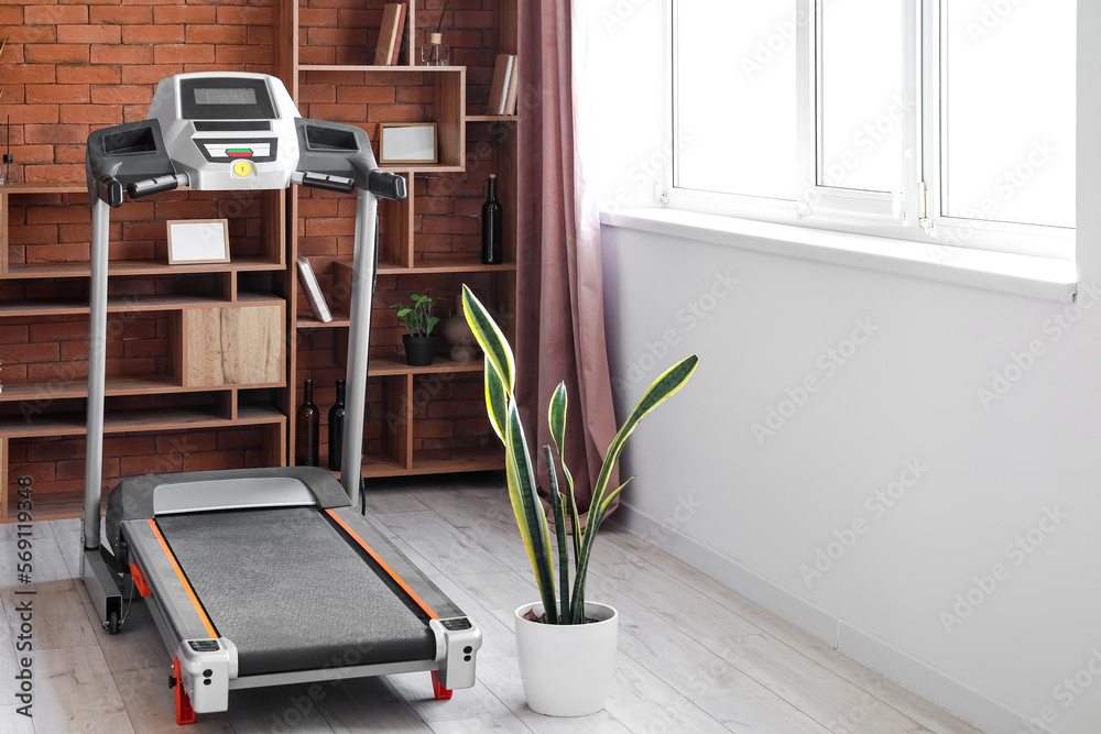 Interior of living room with modern treadmill Stock Photo | Adobe Stock
