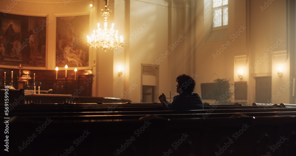Young Christian Man Sits Piously in Majestic Church, with Folded Hands ...