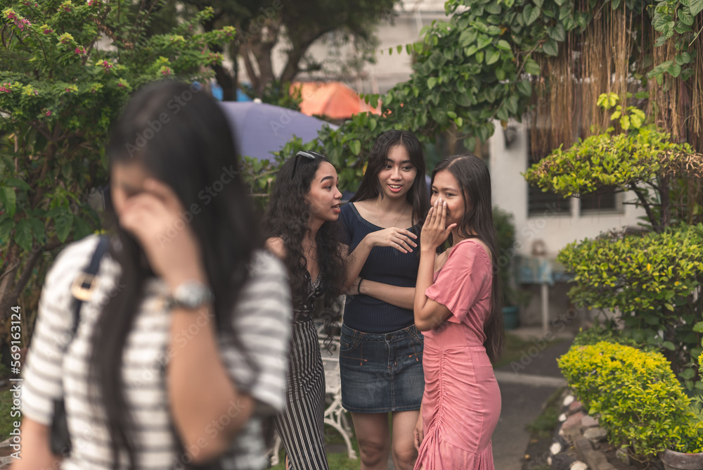 A clique of three mean girls talk and bad-mouth about a poor woman who ...