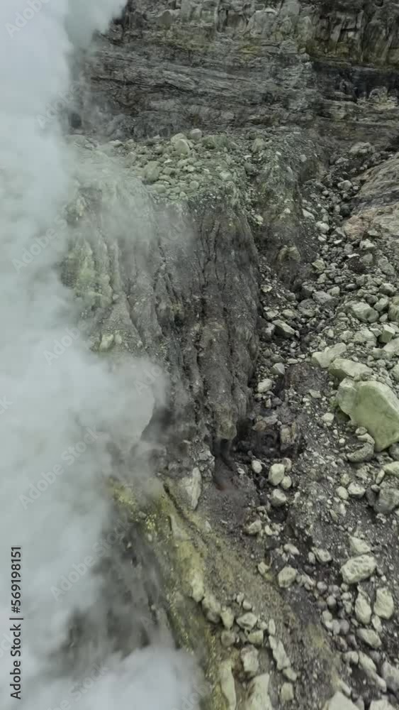 Dive to volcano crater island mountain rock crack stone sharp with acid ...