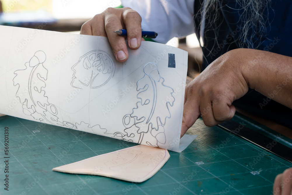 Close-up hand-raising tracing paper which is clear paper, with clear ...