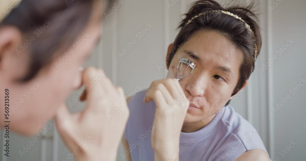 Gay queer man non-binary beauty blogger makeup artist at home cross ...