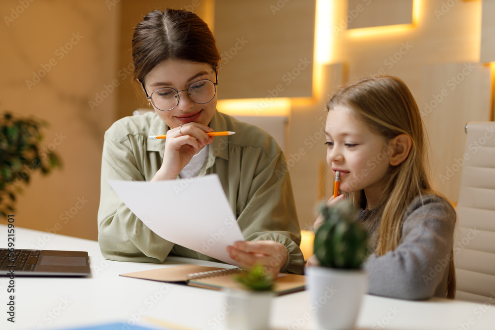 The teacher explains the lesson to the student. Exam results, mom and ...