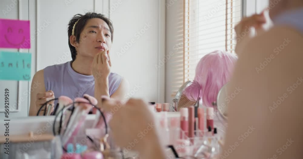 Gay queer man non-binary beauty blogger makeup artist at home cross ...