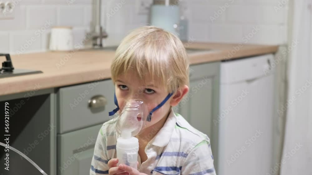 Sick Baby Boy with making Inhalation with a Mask on his Face sitting in ...
