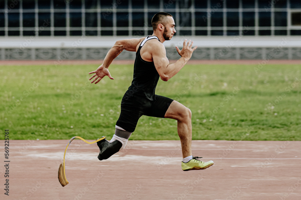 Foto de male paraathlete running in track stadium do Stock | Adobe Stock