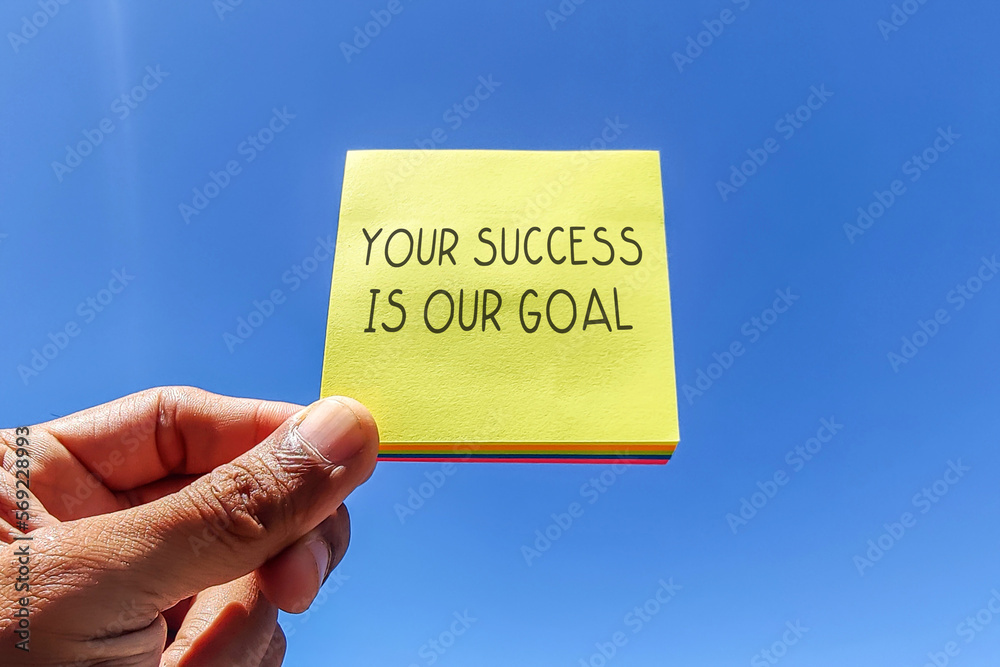 Your success is our goal. Text on yellow adhesive note with sky ...