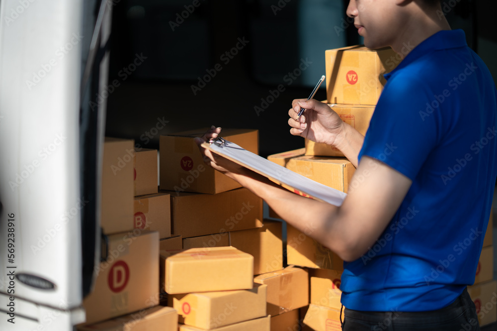Professional delivery man checking delivery list before handed to his ...