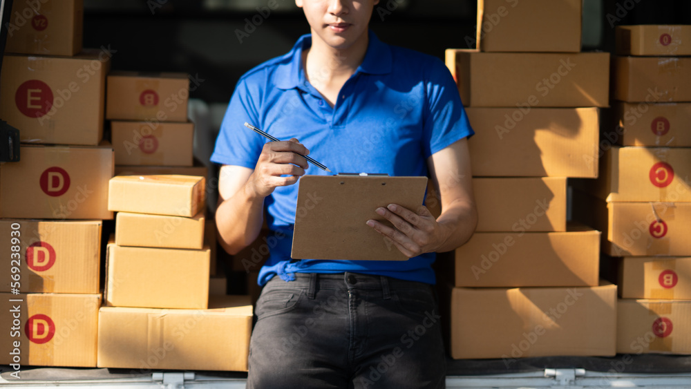 Professional delivery man checking delivery list before handed to his ...