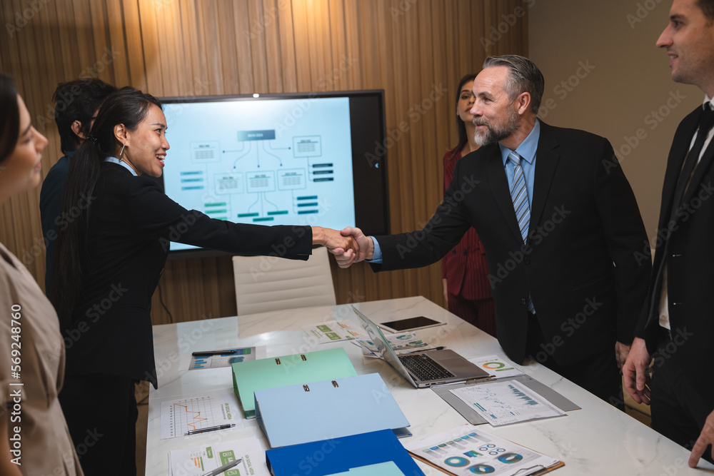 Senior, matured and successful business man in formal clothing greeting ...