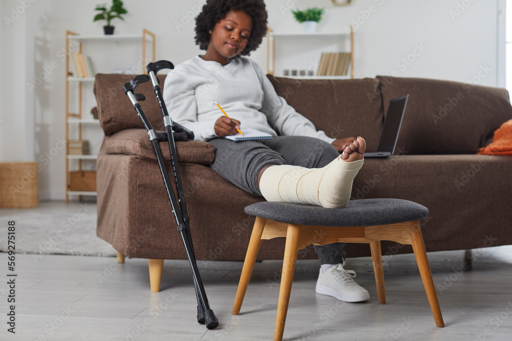 Attractive smiling african american woman works at home in the living ...