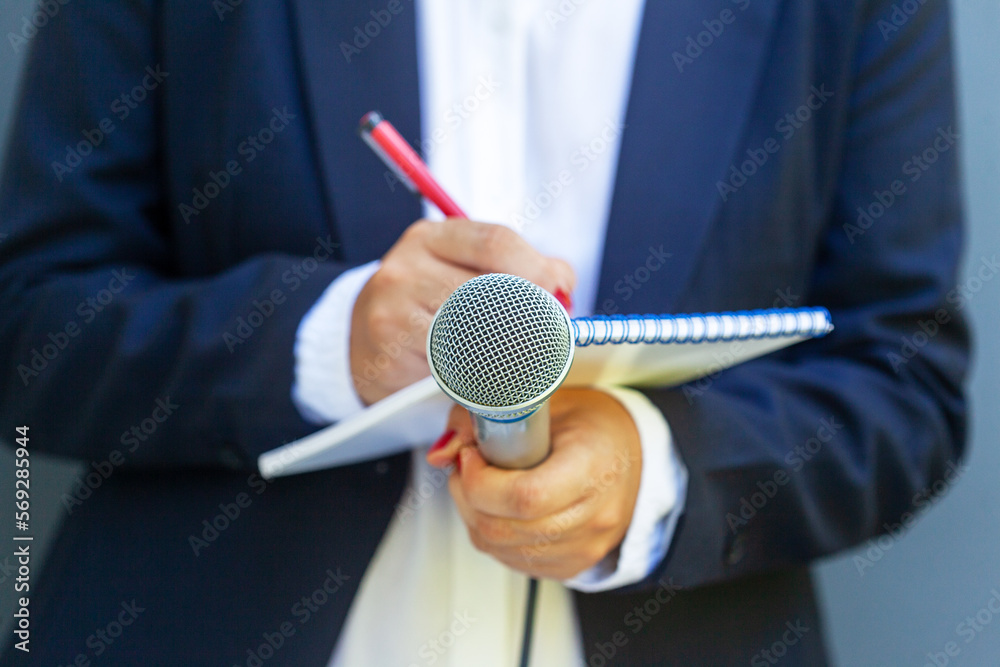 Journalist or reporter at media event, writing fake news, holding ...