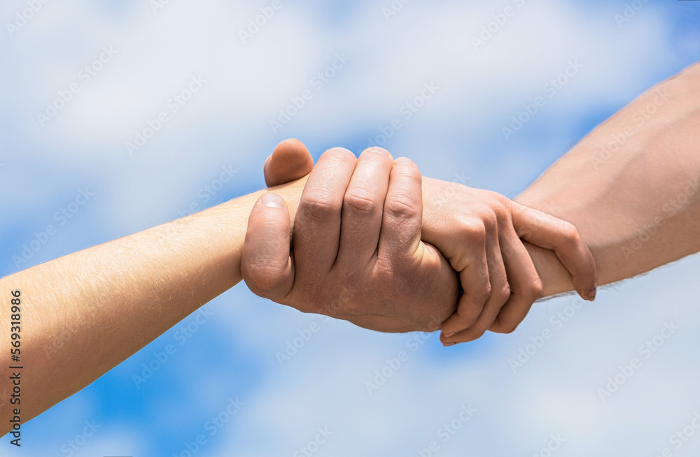 Giving a helping hand. Hands of man and woman on blue sky background ...