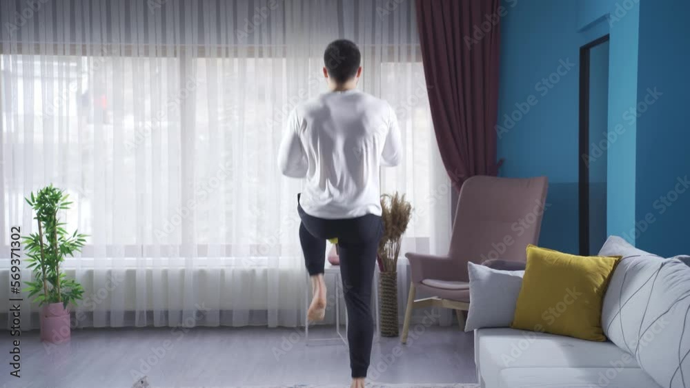 Athlete young man exercising by pulling his legs to his stomach. Young ...