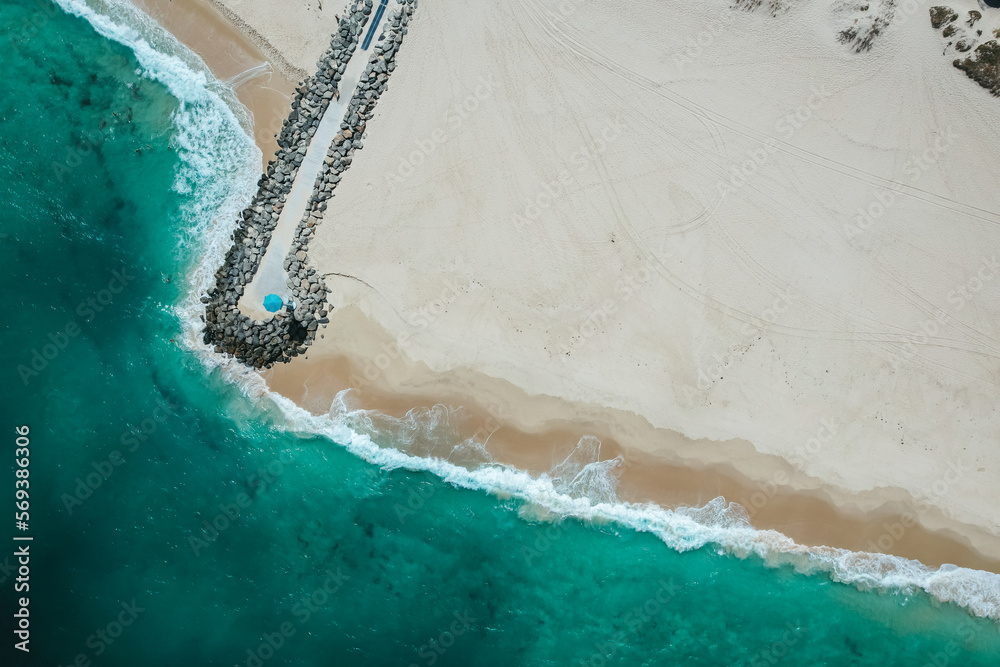 Top down drone capture of City Beach with the rocky groyne and lookout ...