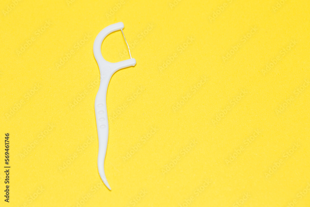 Plastic toothpick on a yellow isolated background. Hygiene and dental ...