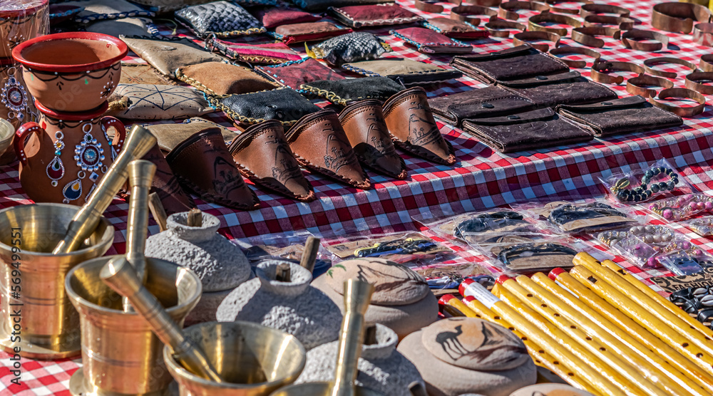 Exposition of souvenir products at a market of Sahara desert. Fabrics ...