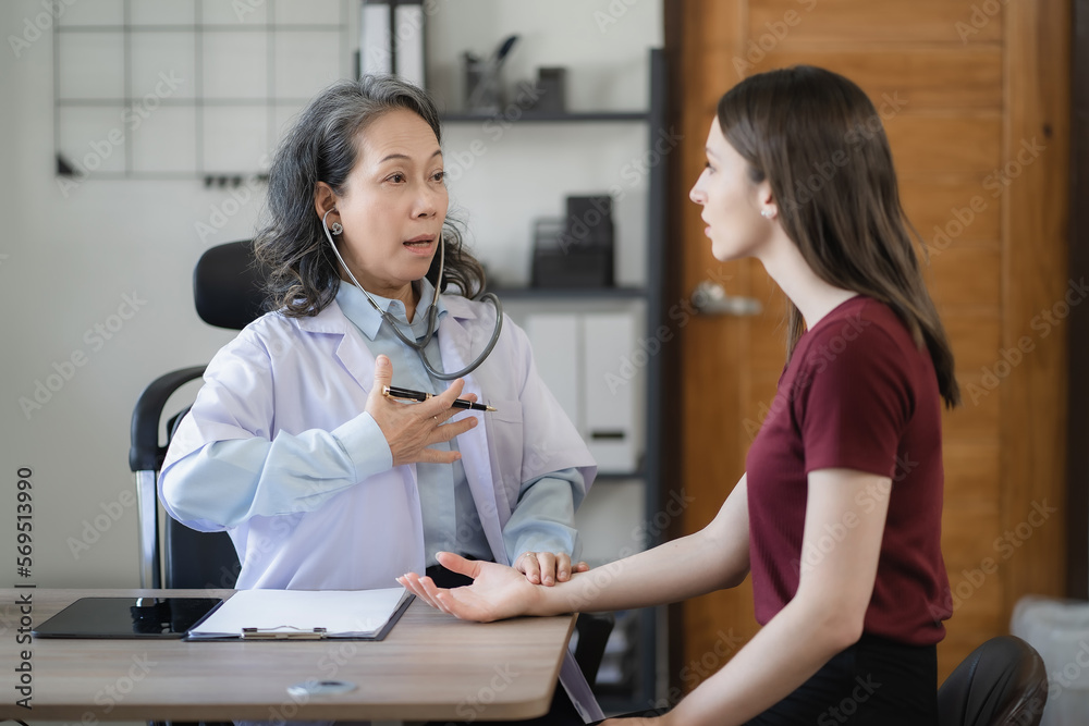 Close up of medical worker putting his fingers on a wrist of a female ...