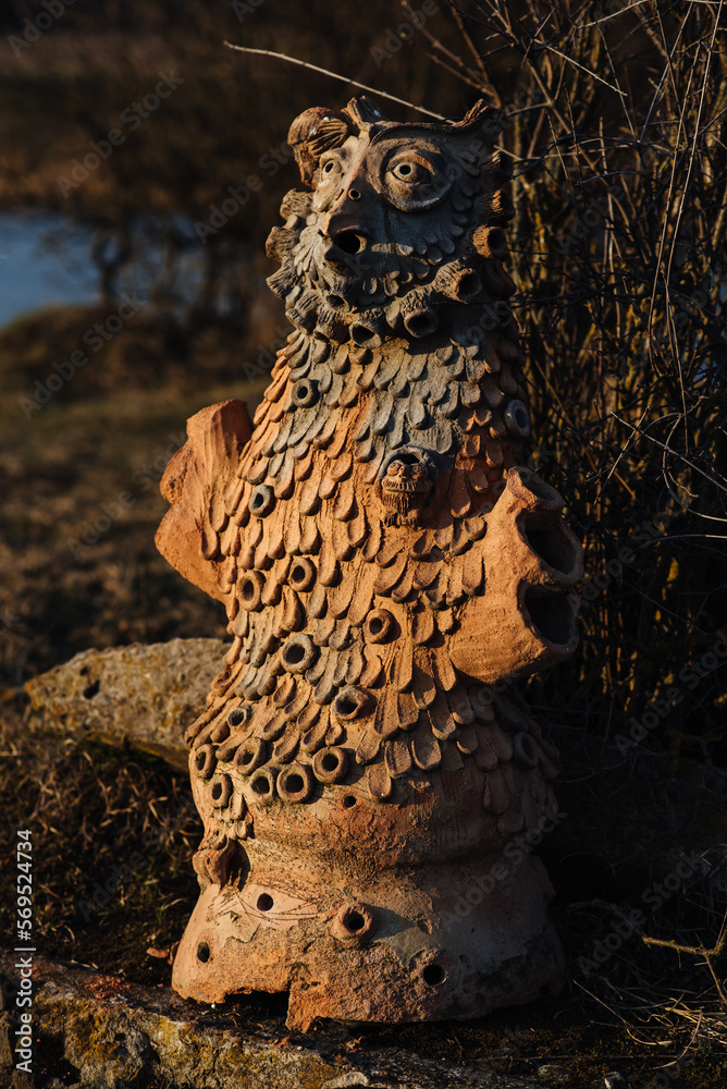 Sculpture of a fantastic ancient pagan god totem idol carved from a ...