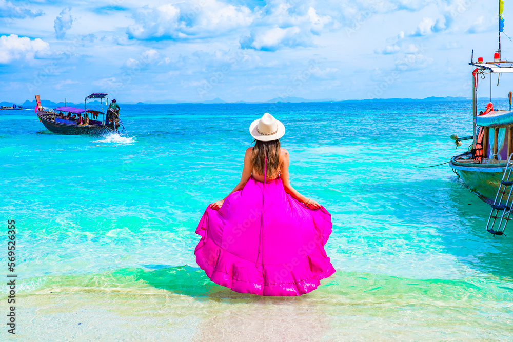 woman in a pink dress on the beach in krabi thailand, chicken island ...