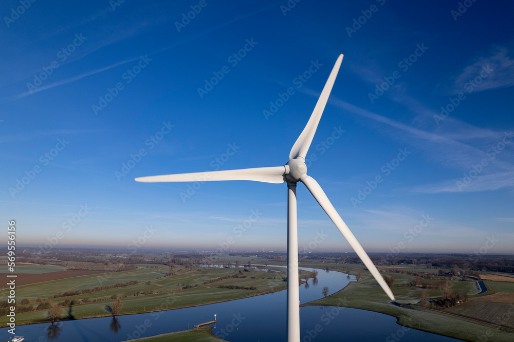 Contrasting closeup of wind turbine and against clear blue sky in The ...