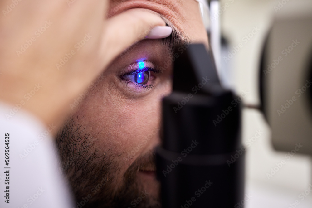 Eye exam, vision or laser test for a man with machine at optometry ...