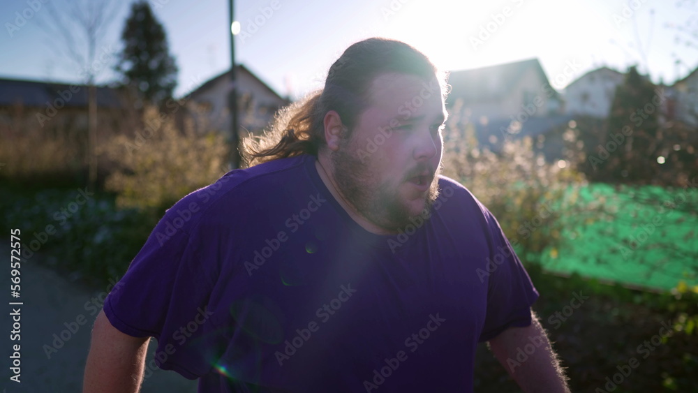 One overweight man starts to run outside getting back to into shape ...