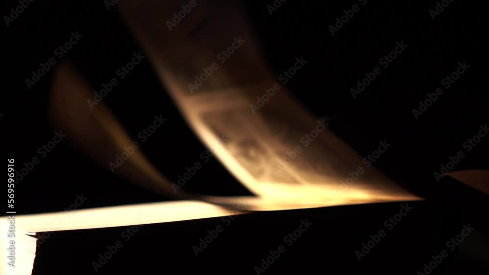 The pages of the book turn over by themselves. Slow-motion video of ...