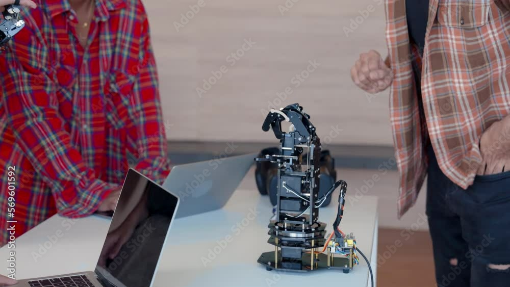 4K, Closeup of robotic hand placed on table robot hand rotates left and ...
