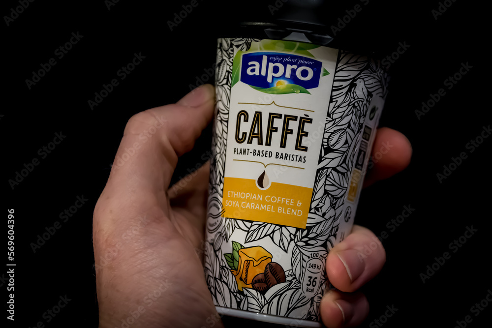 Hand holding Alpro plant based barista latte caffe or coffee. Ethiopian ...